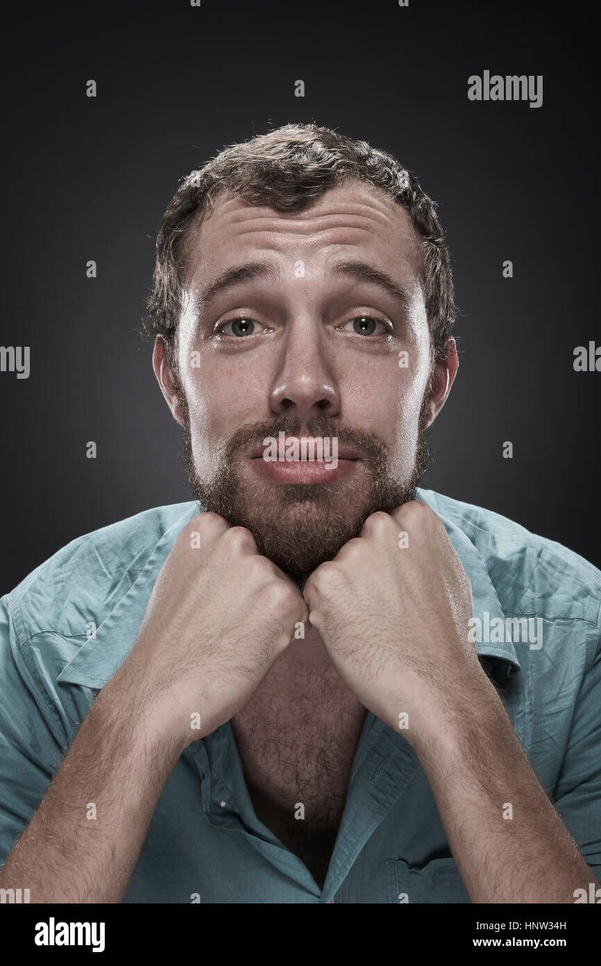 Sad man with hands on chin Stock Photo - Alamy