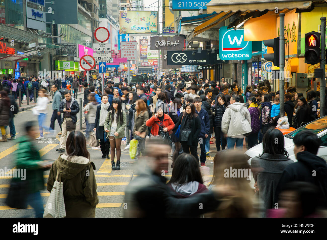 Hong Kong - FEBRUARY 18: People crossing the street at Mong Kok ...