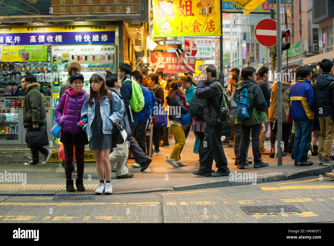 Hong Kong - FEBRUARY 18: People crossing the street at Mong Kok ...