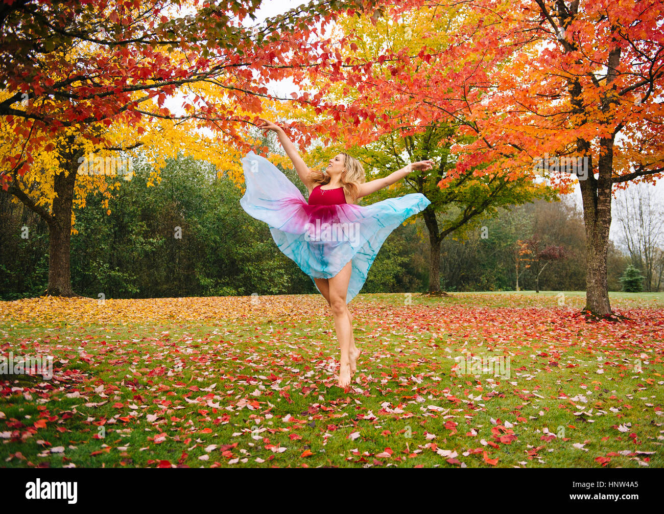 Caucasian ballerina dancing in autumn leaves in park Stock Photo - Alamy