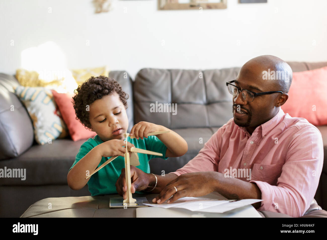 Father and son building model windmill in livingroom Stock Photo - Alamy
