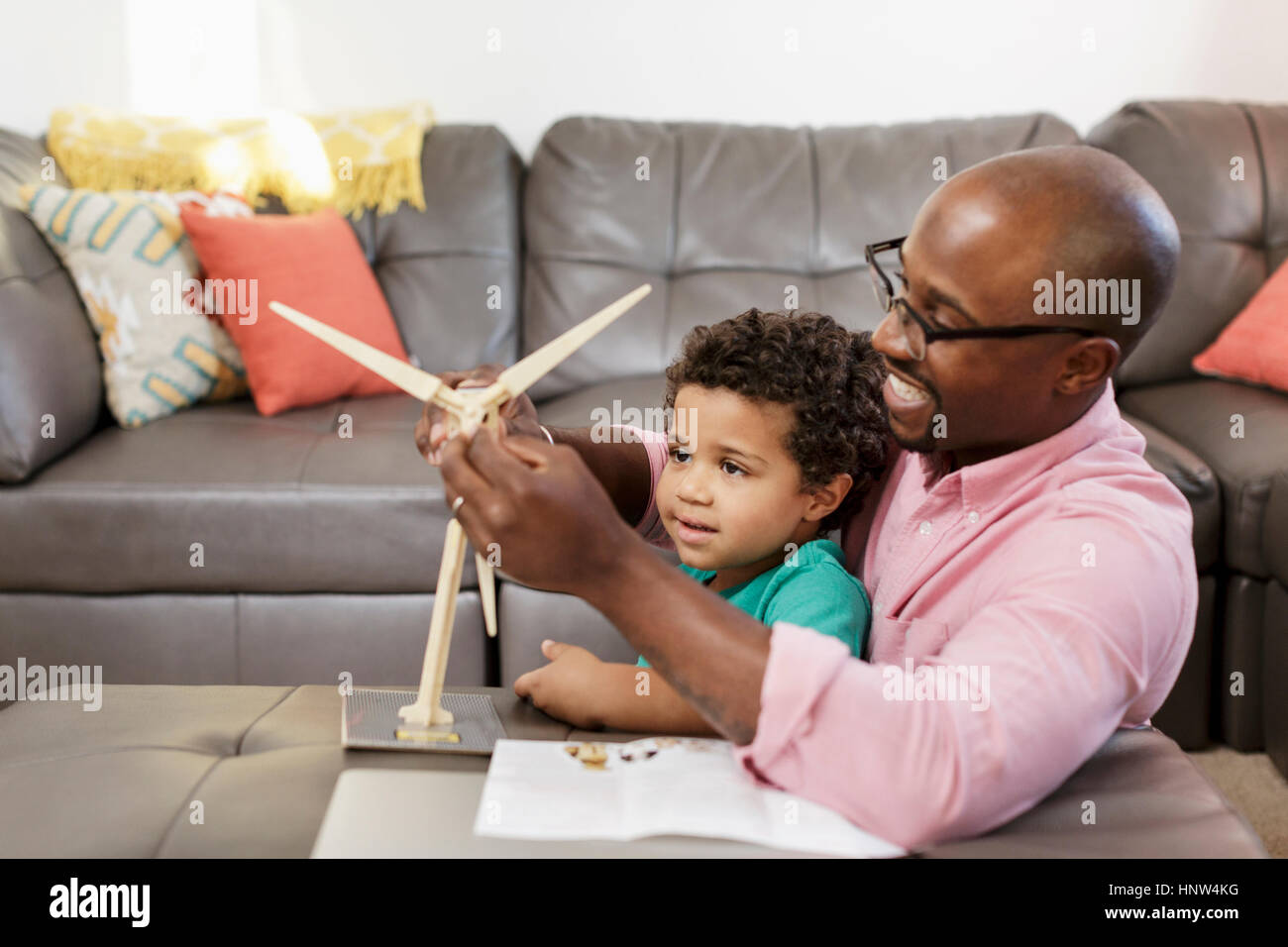 Father and son building model windmill in livingroom Stock Photo - Alamy