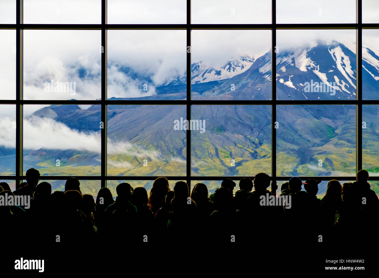 Crowd at window with scenic view of mountain Stock Photo - Alamy