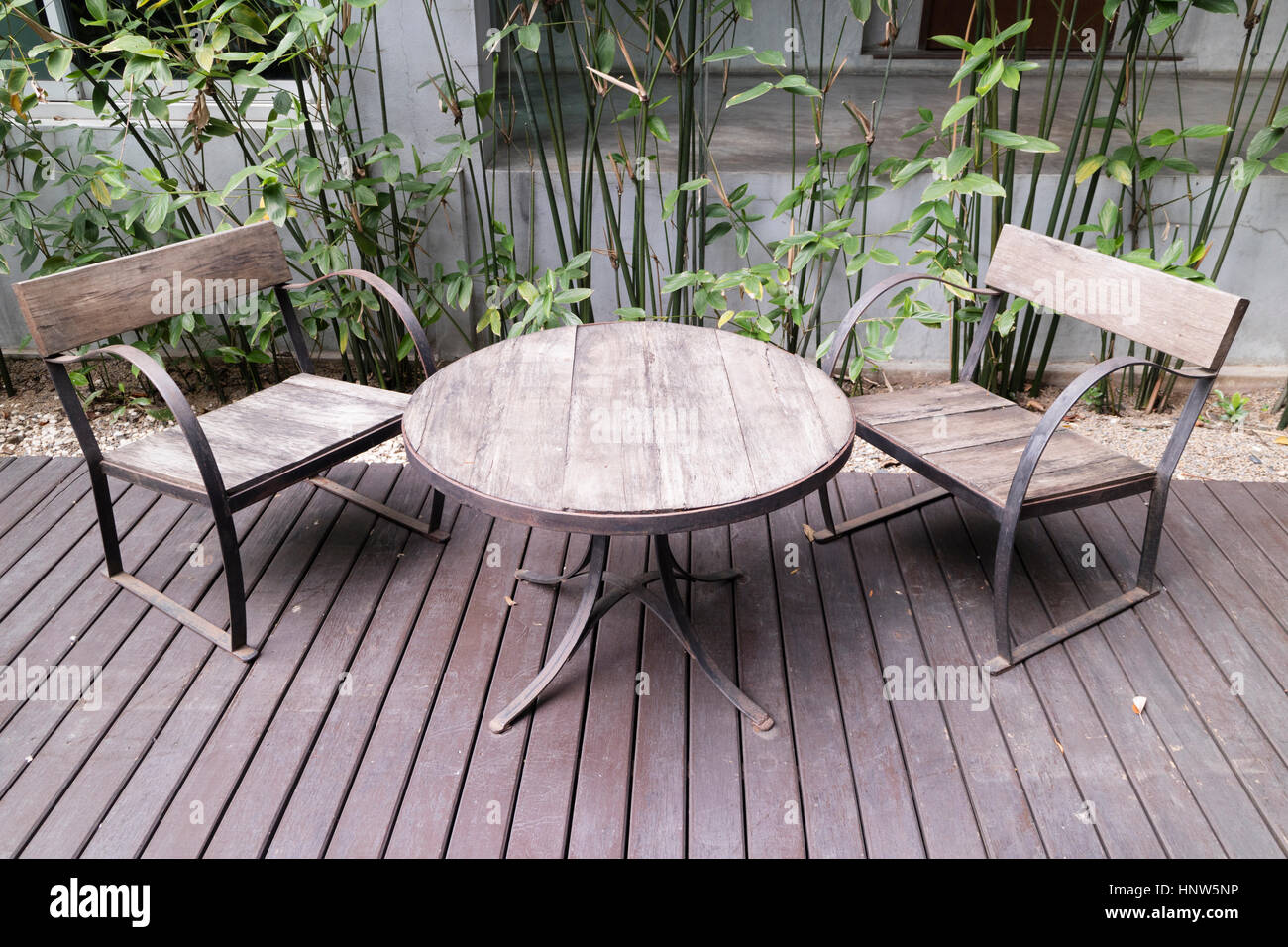 wooden desk and chair on patio beside garden Stock Photo - Alamy