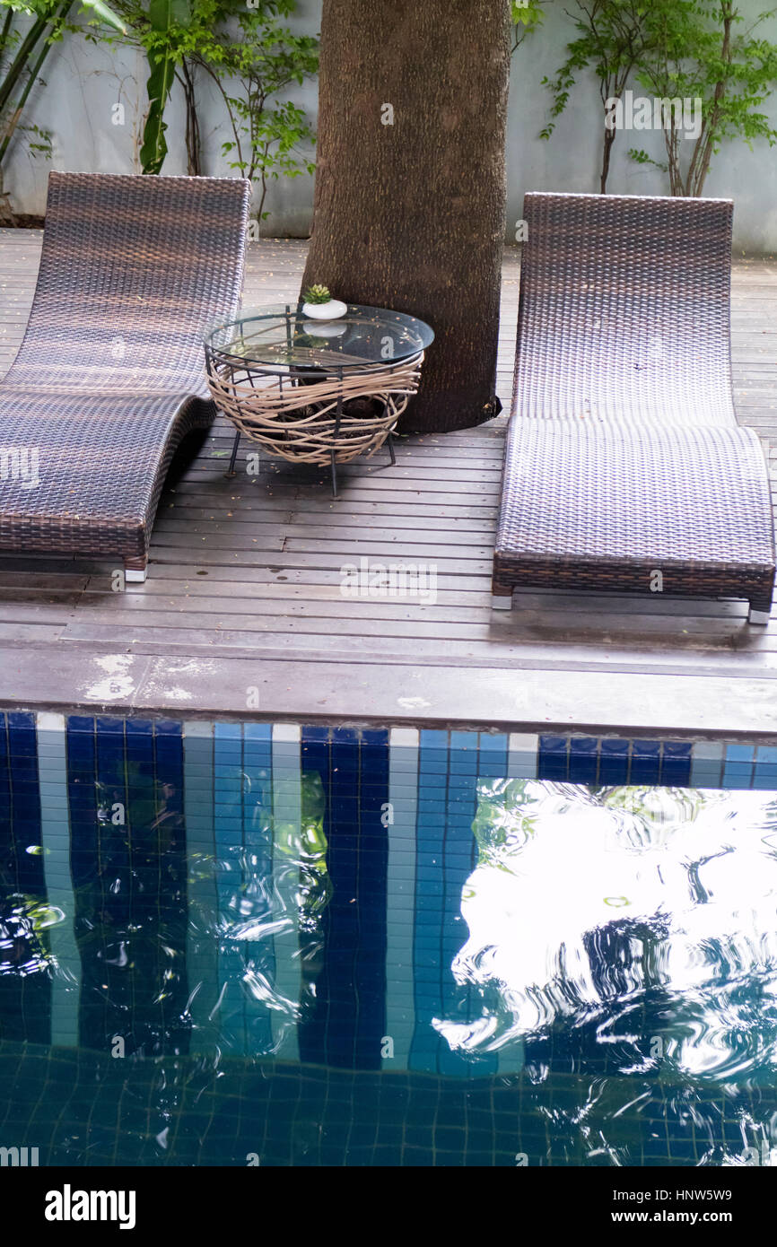 Wicker chair by swimming pool hi-res stock photography and images - Alamy