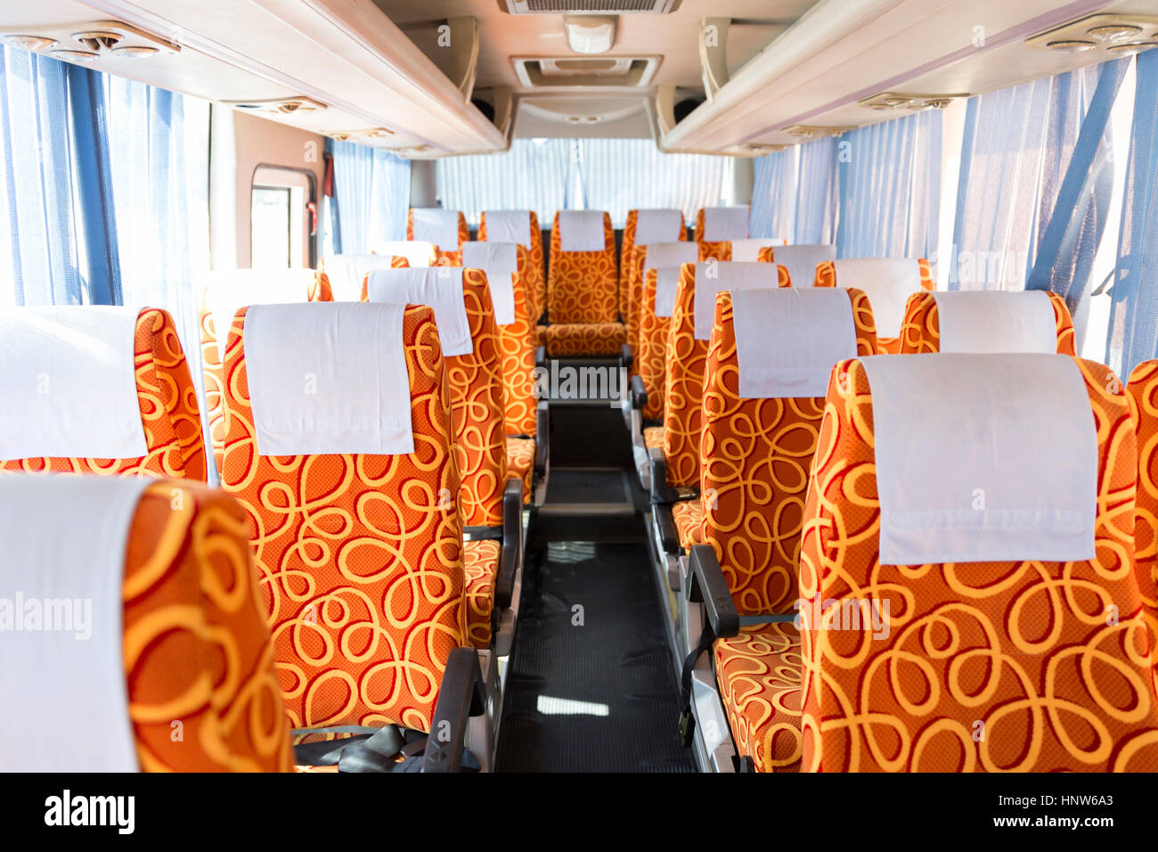 orange fabric vehicle seat in interior mini bus Stock Photo - Alamy