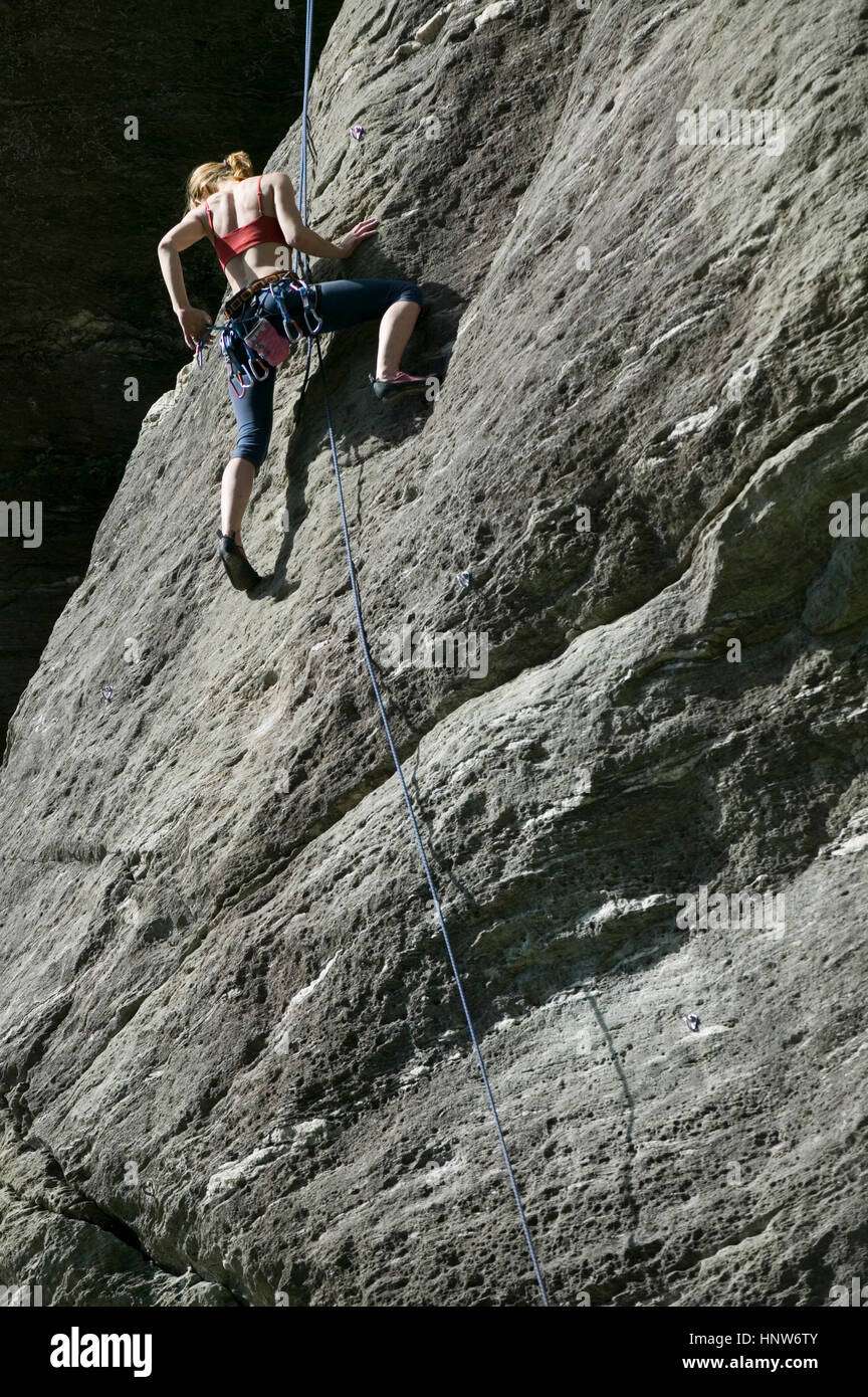 Rock climber climbing rock face Stock Photo - Alamy