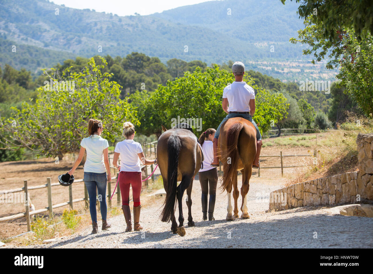Woman leading horse rider hi-res stock photography and images - Alamy