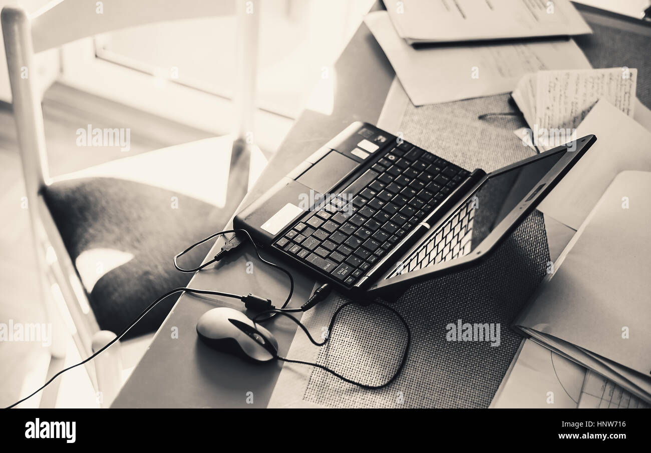 Working table with laptop and lot of written papers Stock Photo - Alamy