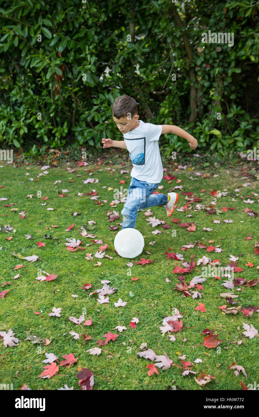 Boy playing football Stock Photo - Alamy
