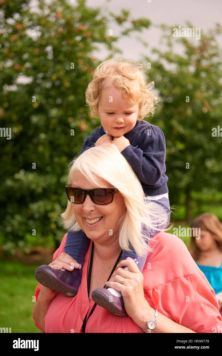Grandmother carrying grandson on shoulders Stock Photo - Alamy