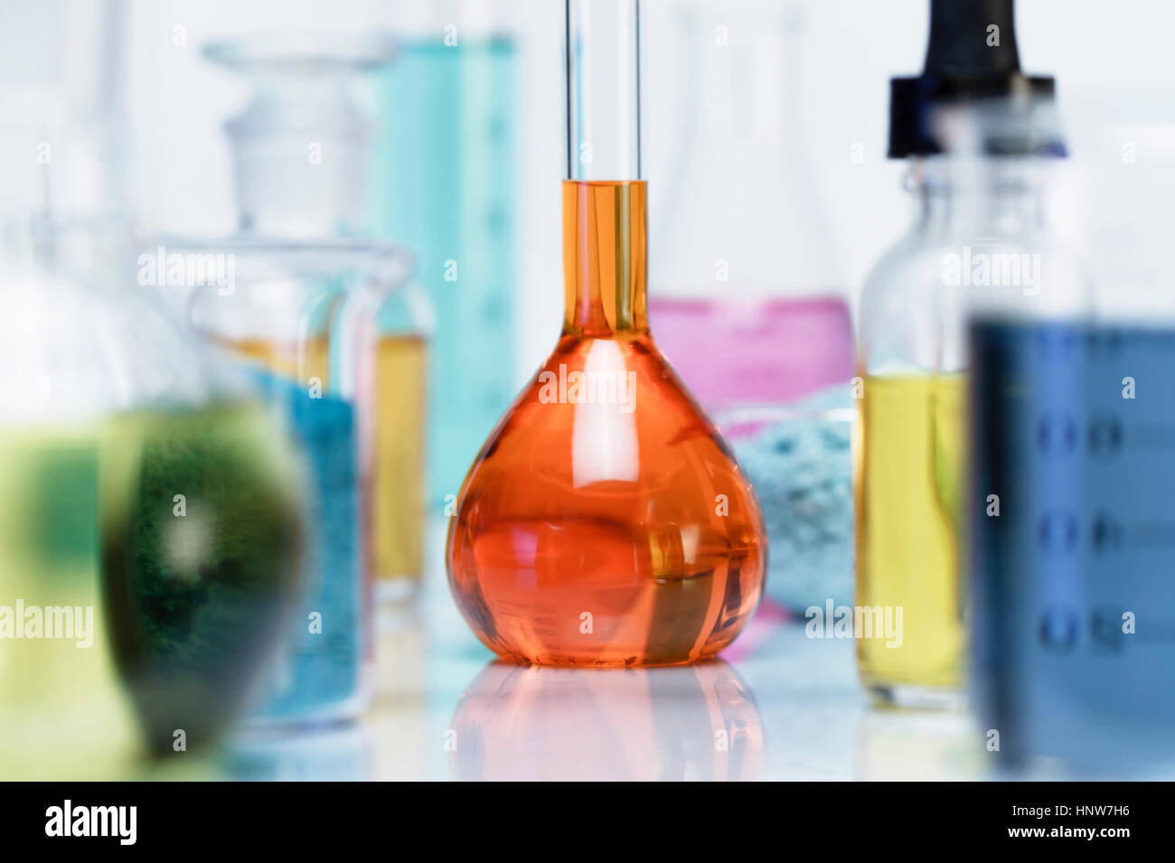 Volumetric flask of potassium dichromate solution, with various flasks ...