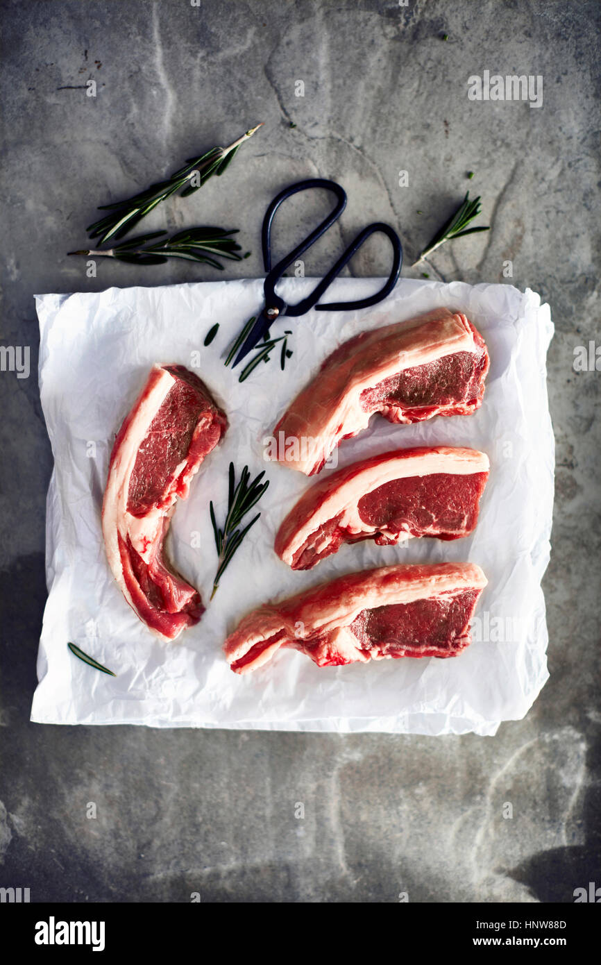 Lamb chops on greaseproof paper, overhead view Stock Photo - Alamy