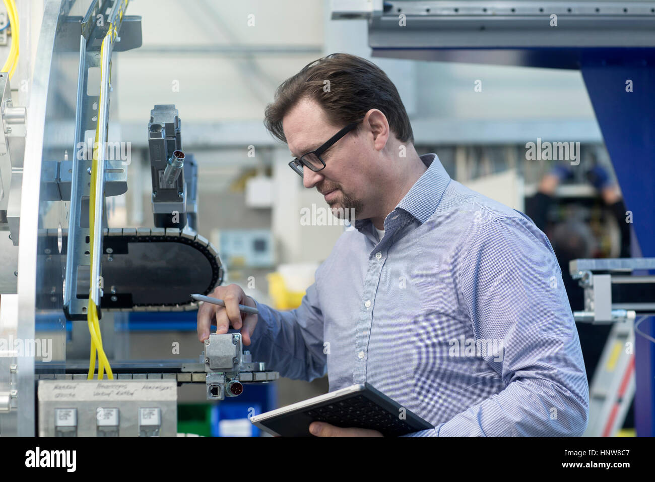 Engineer working in industrial plant Stock Photo - Alamy