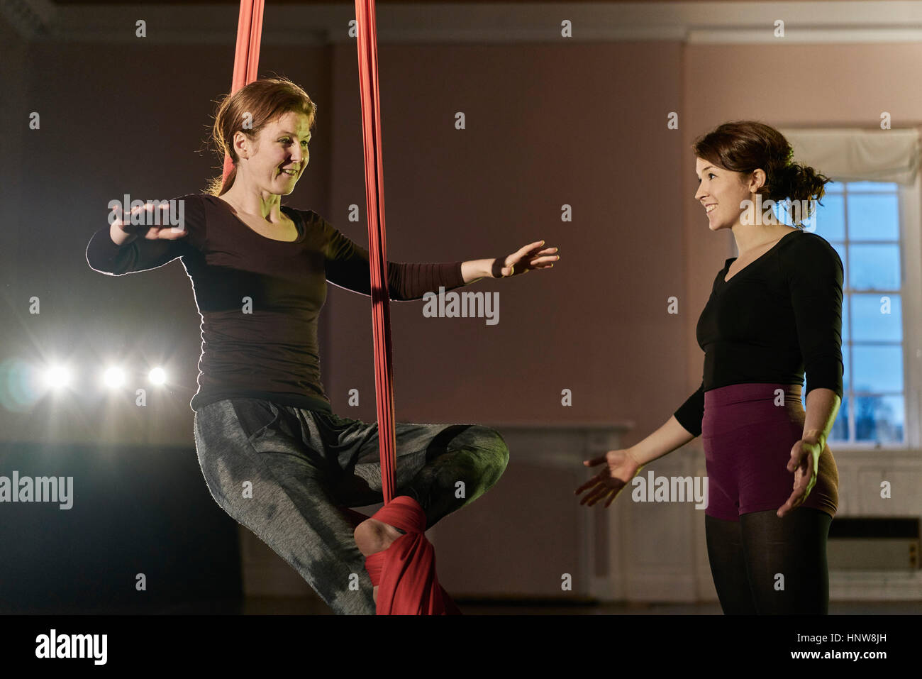Two young female aerial acrobats practicing balance on silk rope Stock ...