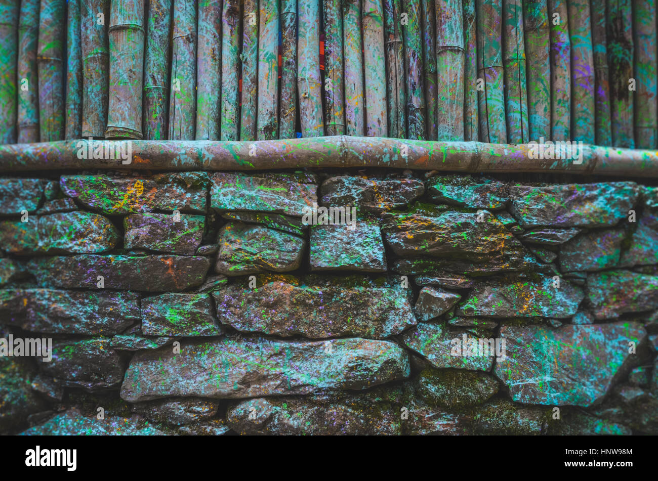 Colorful paint splatter on stone wall Stock Photo - Alamy
