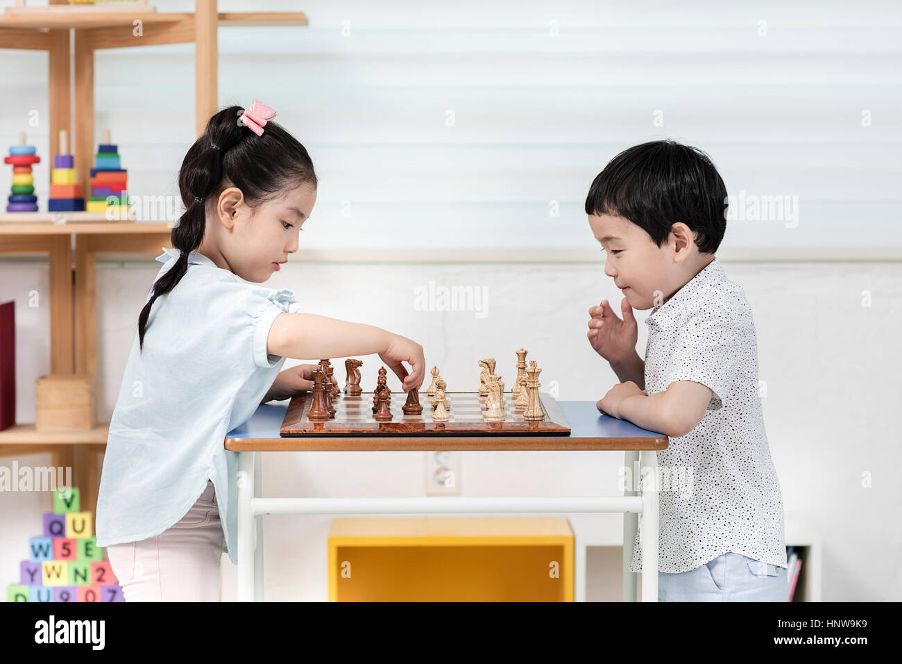 Kindergarten kids playing board game Stock Photo - Alamy