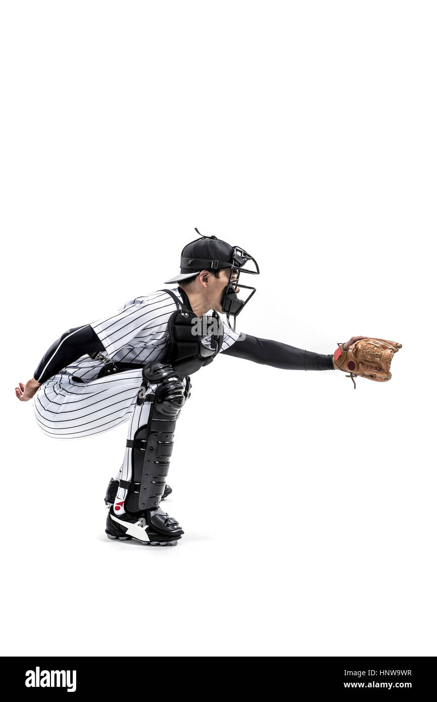 Side view of baseball catcher sitting Stock Photo - Alamy