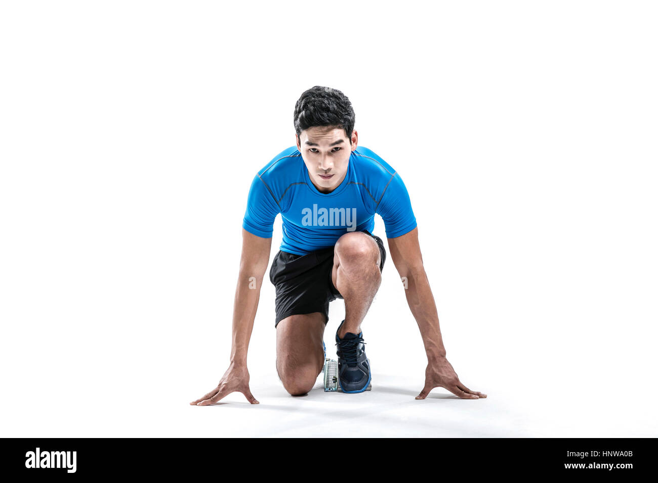 Male athlete sitting starting at front Stock Photo - Alamy