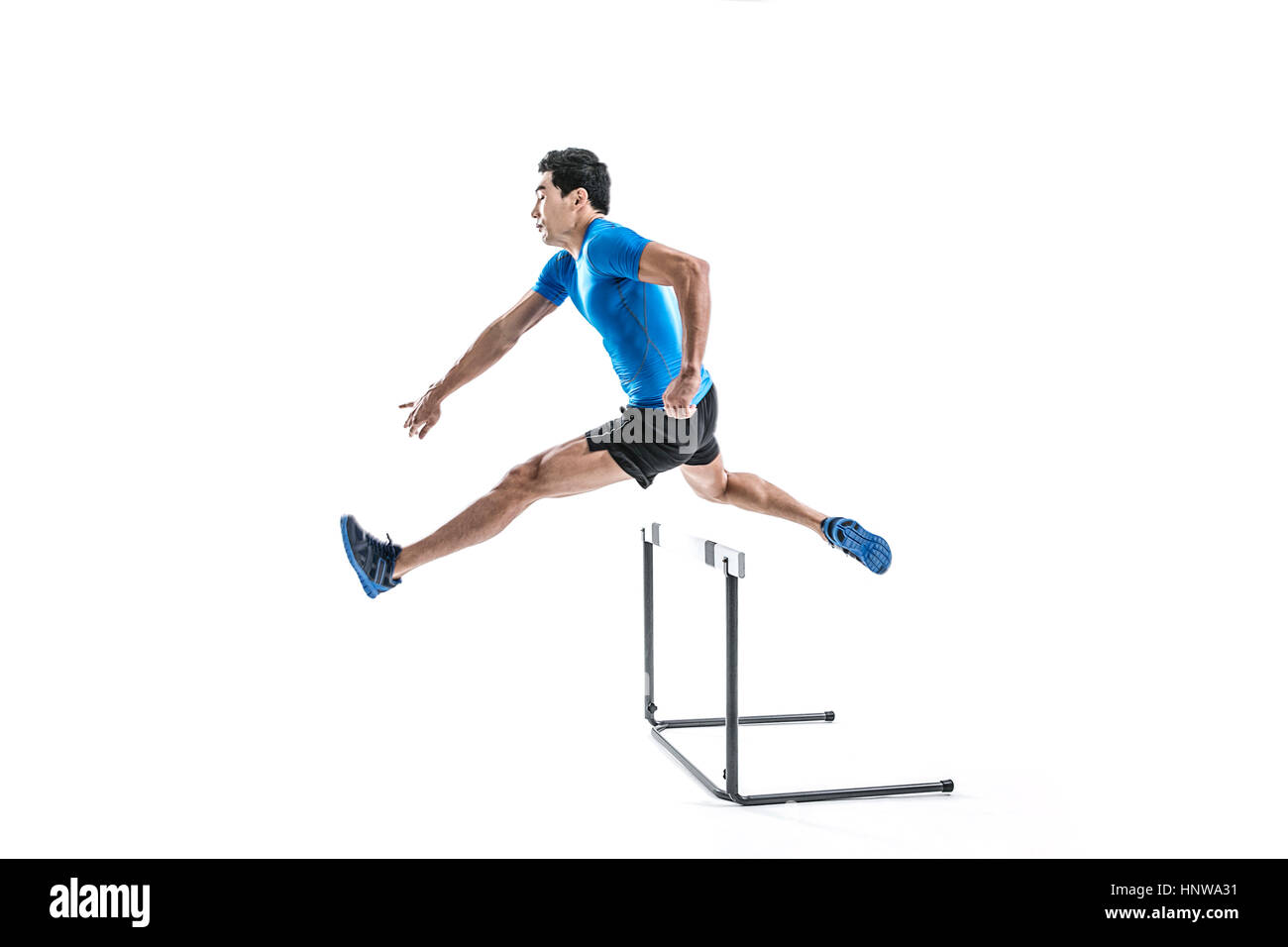 Male athlete jumping over obstacle Stock Photo - Alamy