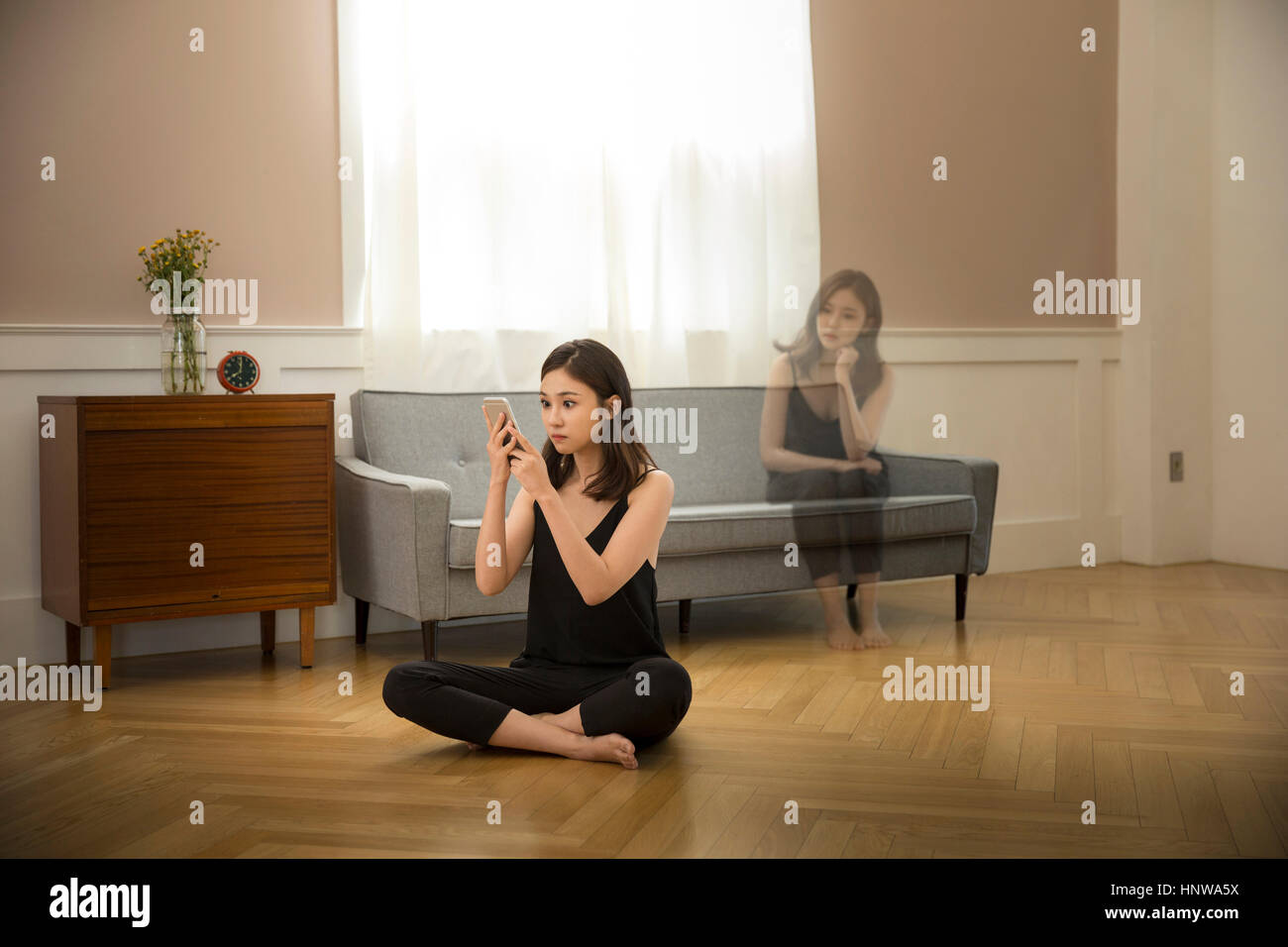 Young woman holding alarm hi-res stock photography and images - Alamy