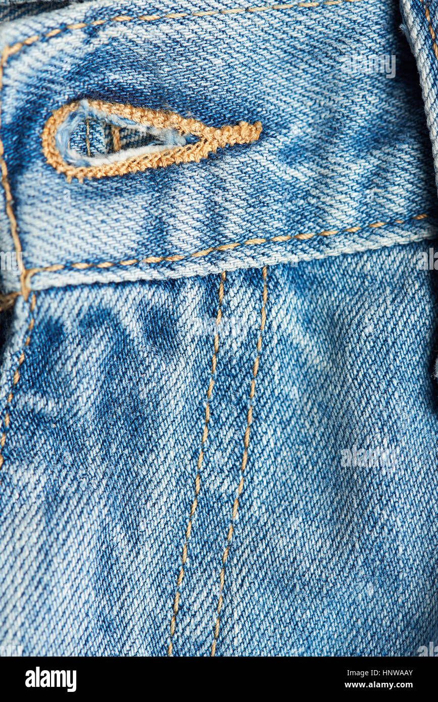 Close up of button hole on light blue jeans close up Stock Photo - Alamy