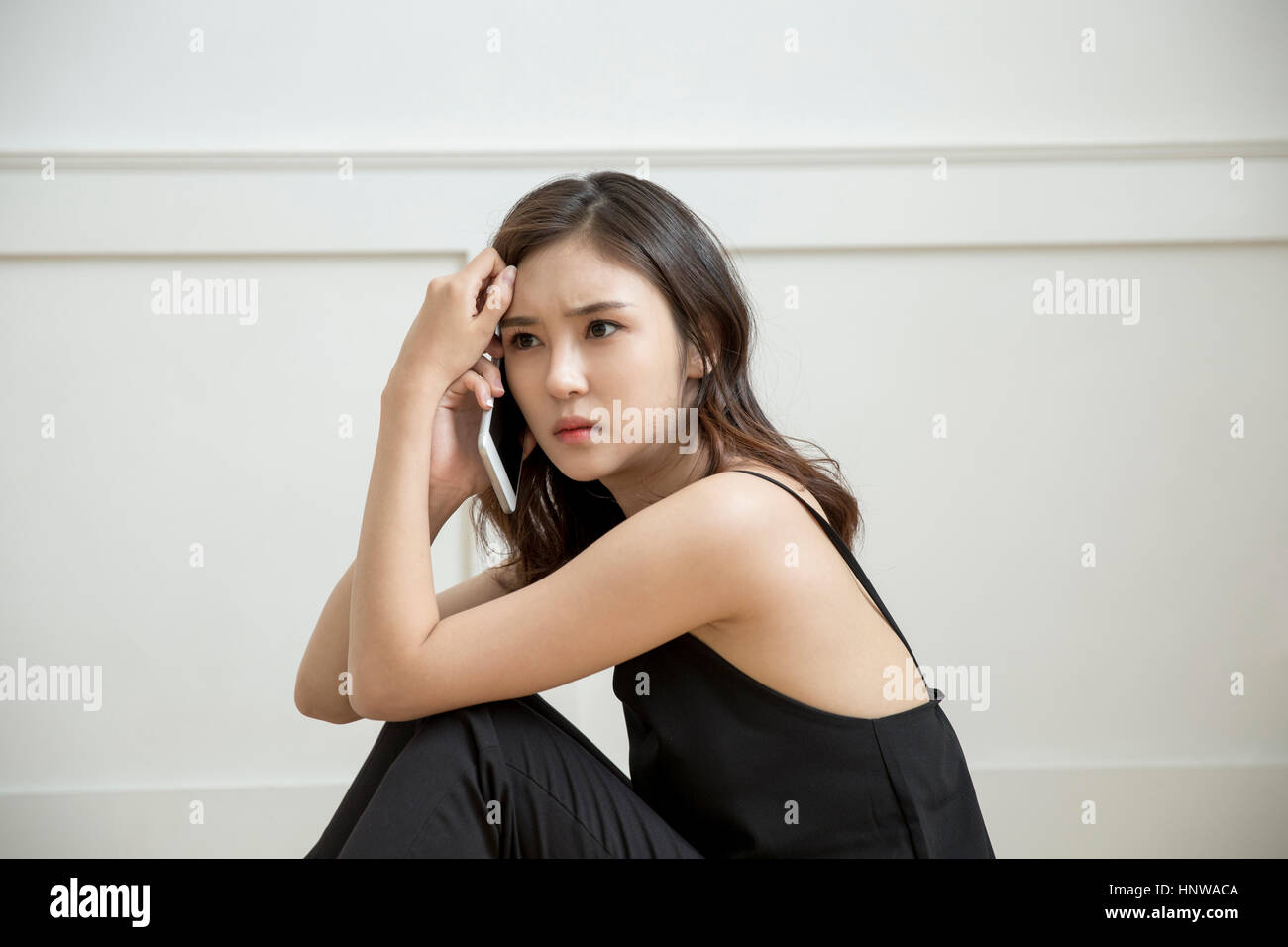 Side view of young woman depressed Stock Photo - Alamy