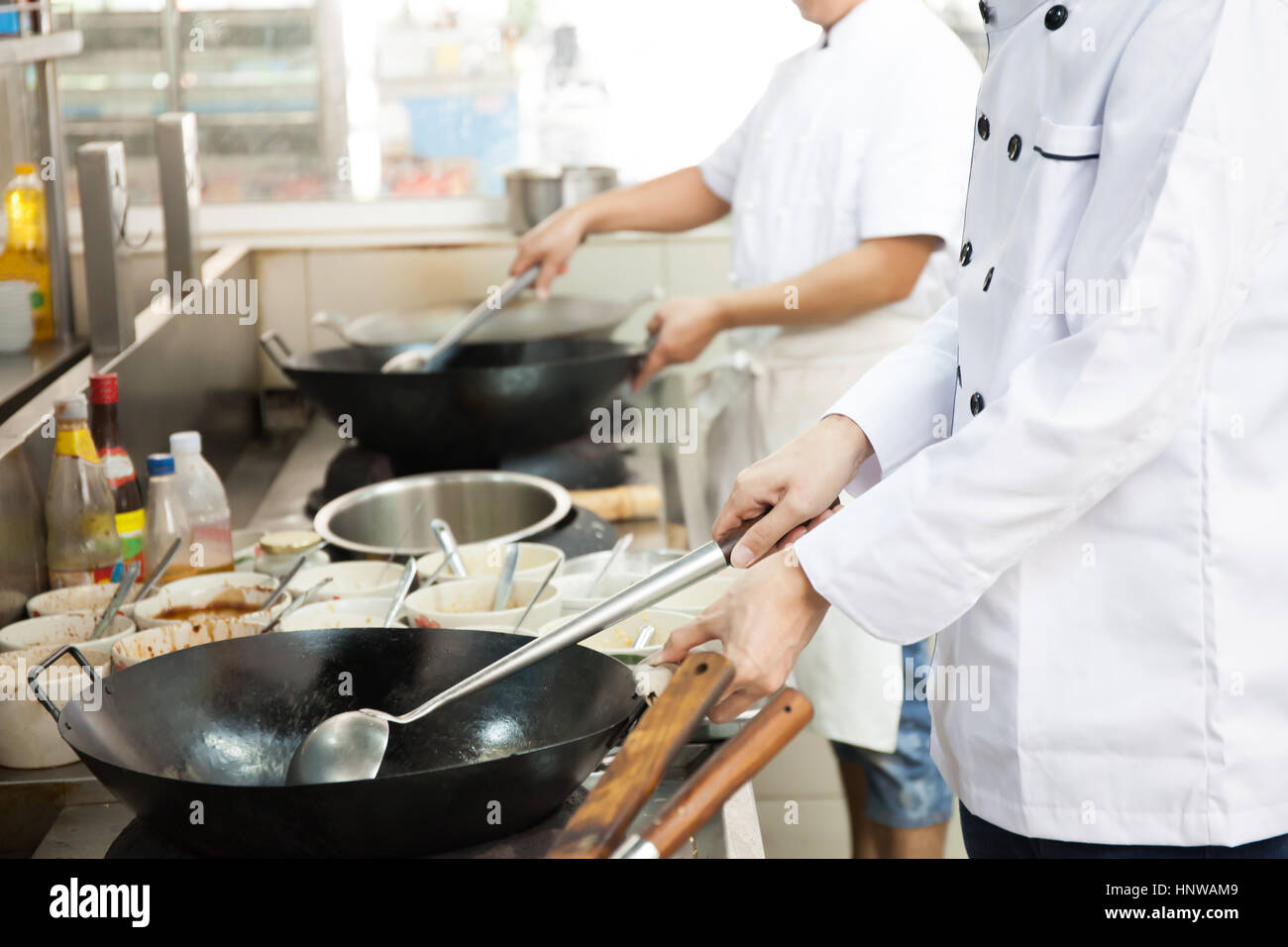 Group of chefs in hotel or restaurant kitchen busy cooking Stock Photo ...