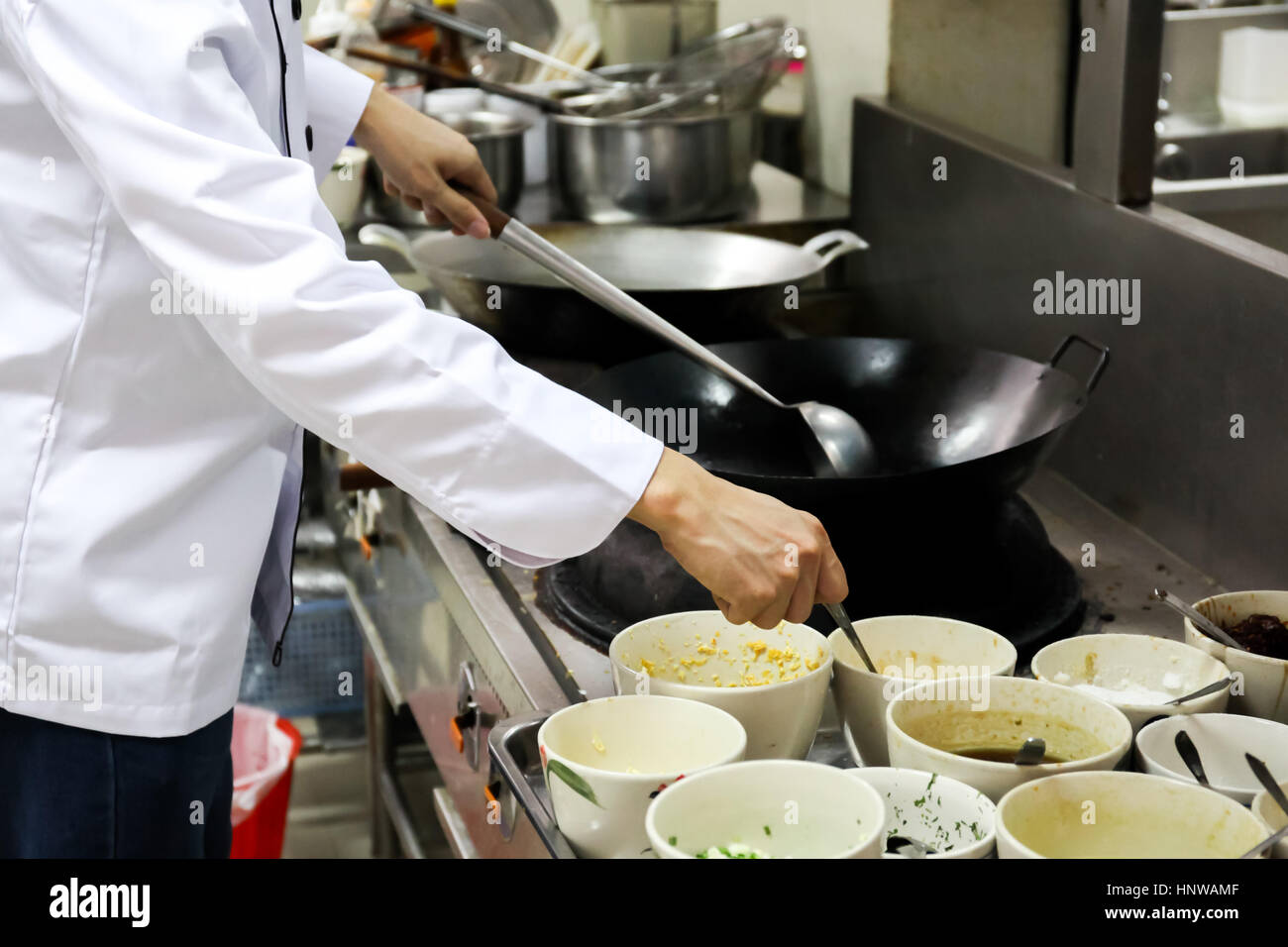 Chef in hotel or restaurant kitchen busy cooking Stock Photo - Alamy