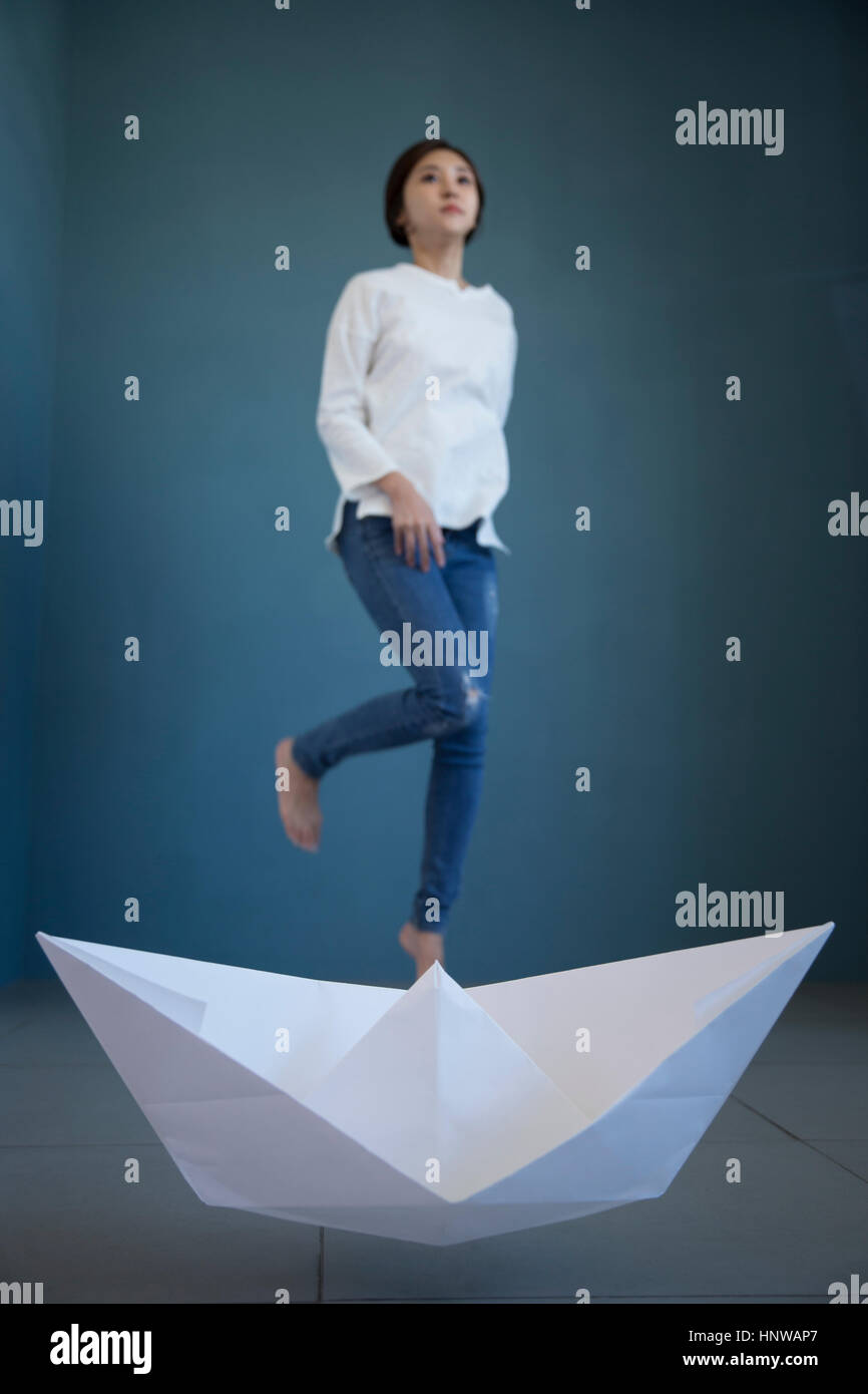 Young woman standing on paper boat Stock Photo - Alamy
