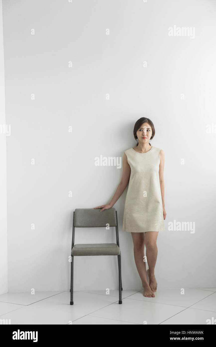 Woman standing with chair hi-res stock photography and images - Alamy