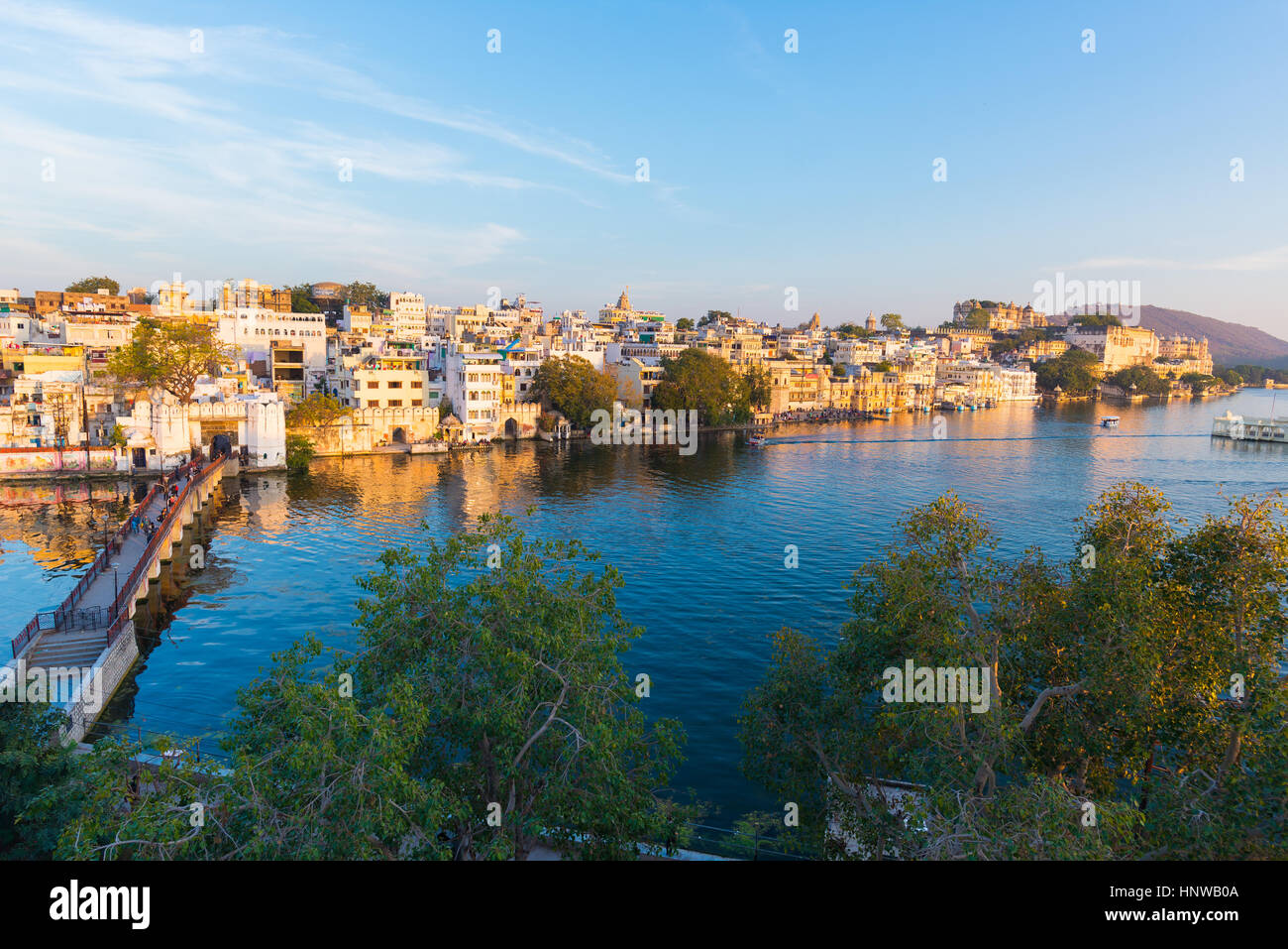 Udaipur cityscape at sunset. The majestic city palace on Lake Pichola ...