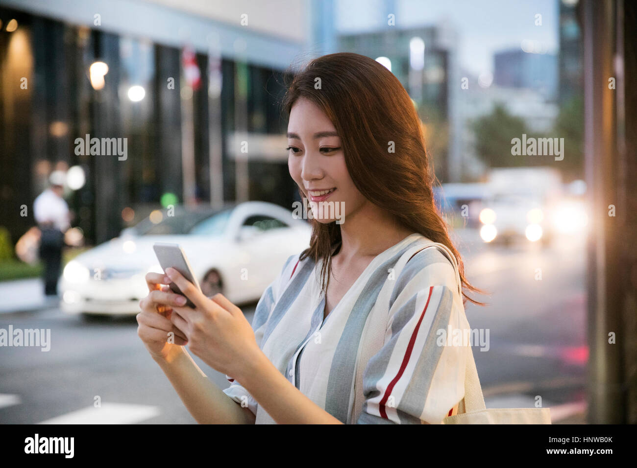 Portrait of young woman using smartphone Stock Photo - Alamy
