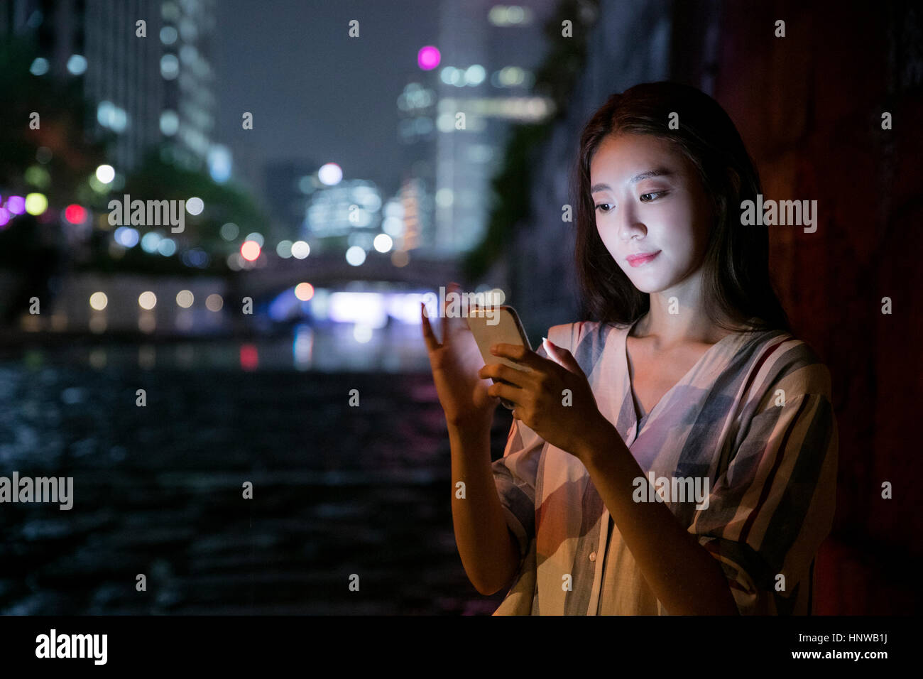 Looking at smartphone night hi-res stock photography and images - Alamy