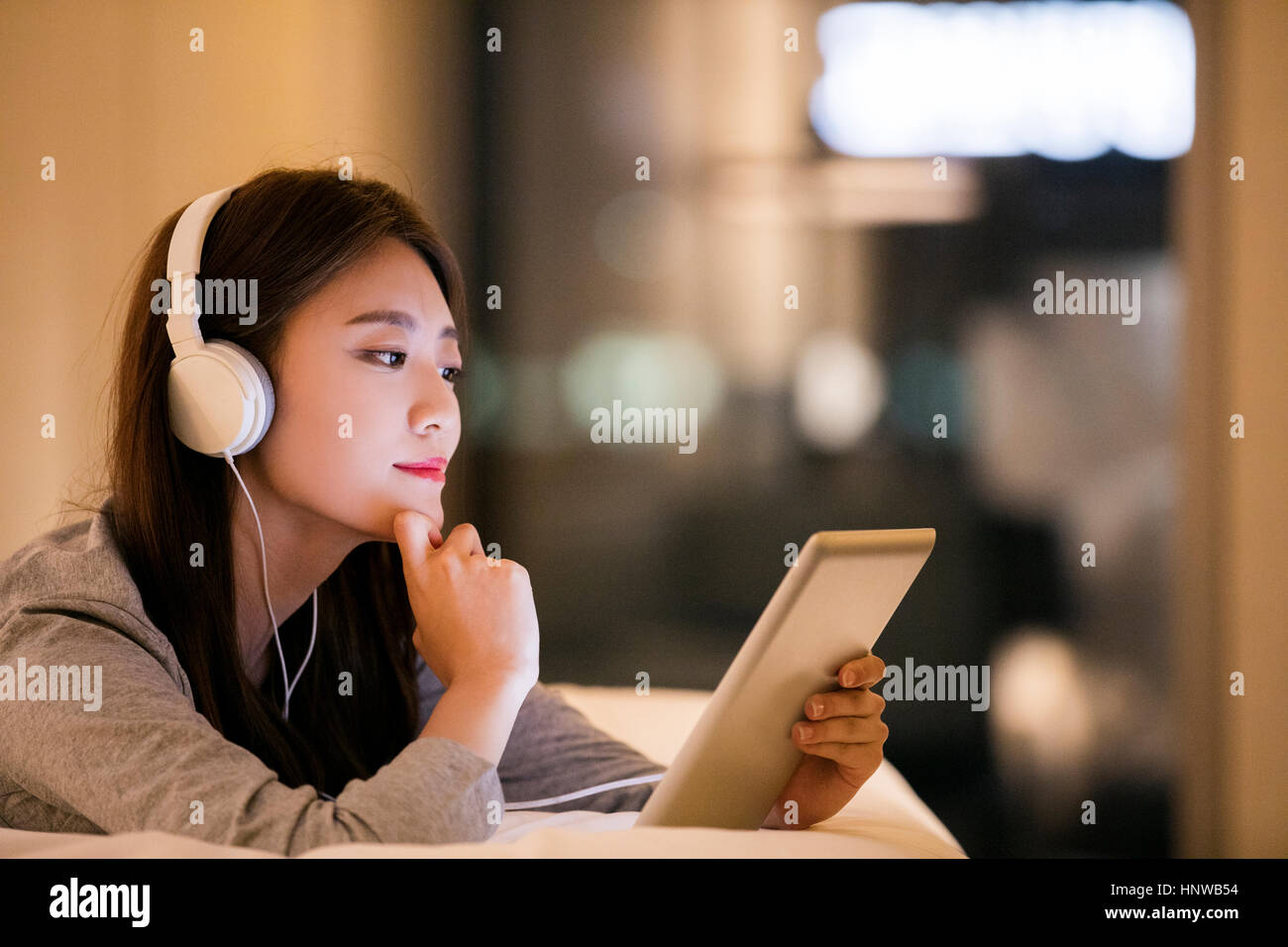 Asian woman headphones tablet hi-res stock photography and images - Alamy