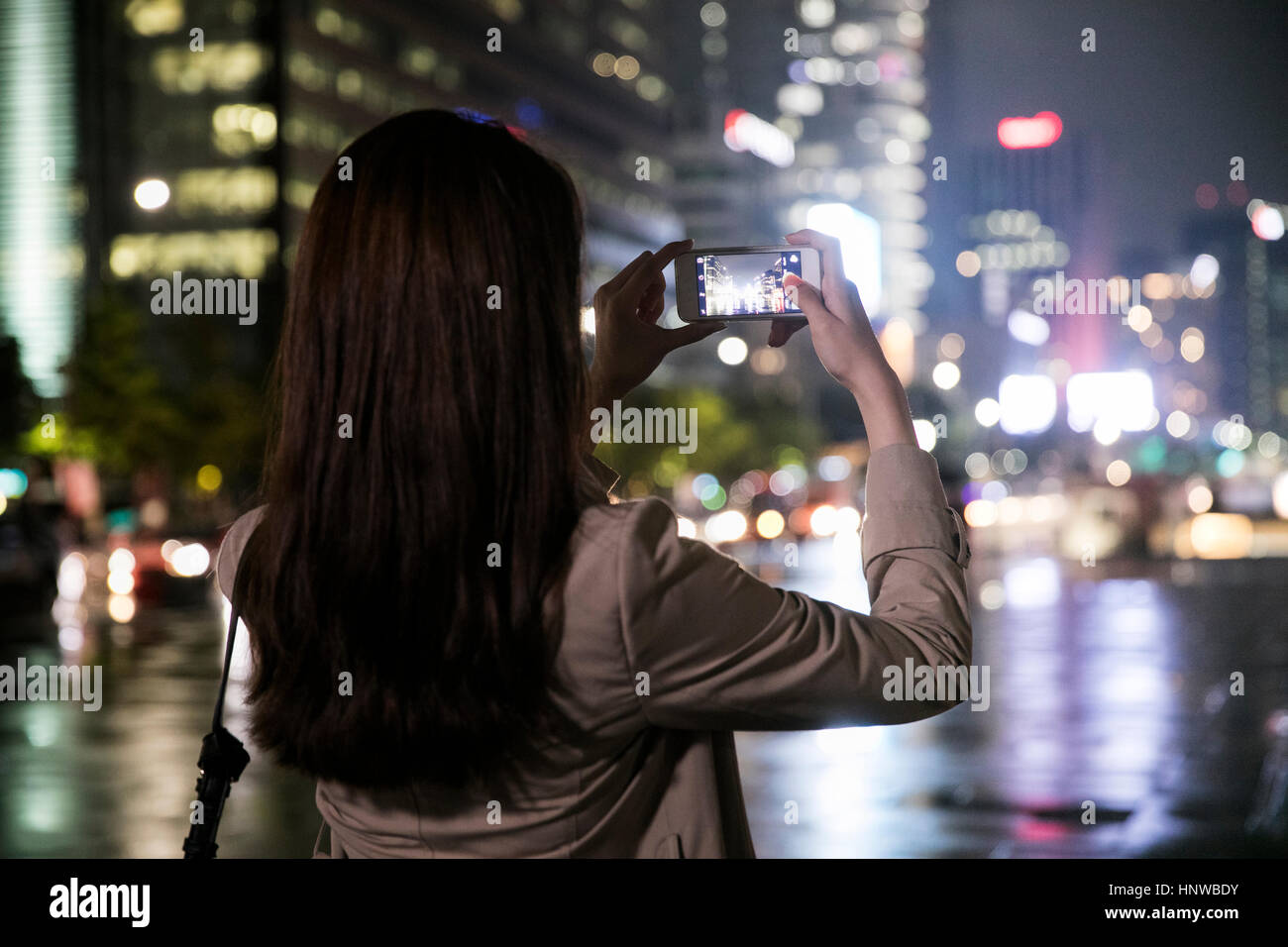 Woman asian phone back view hi-res stock photography and images - Alamy