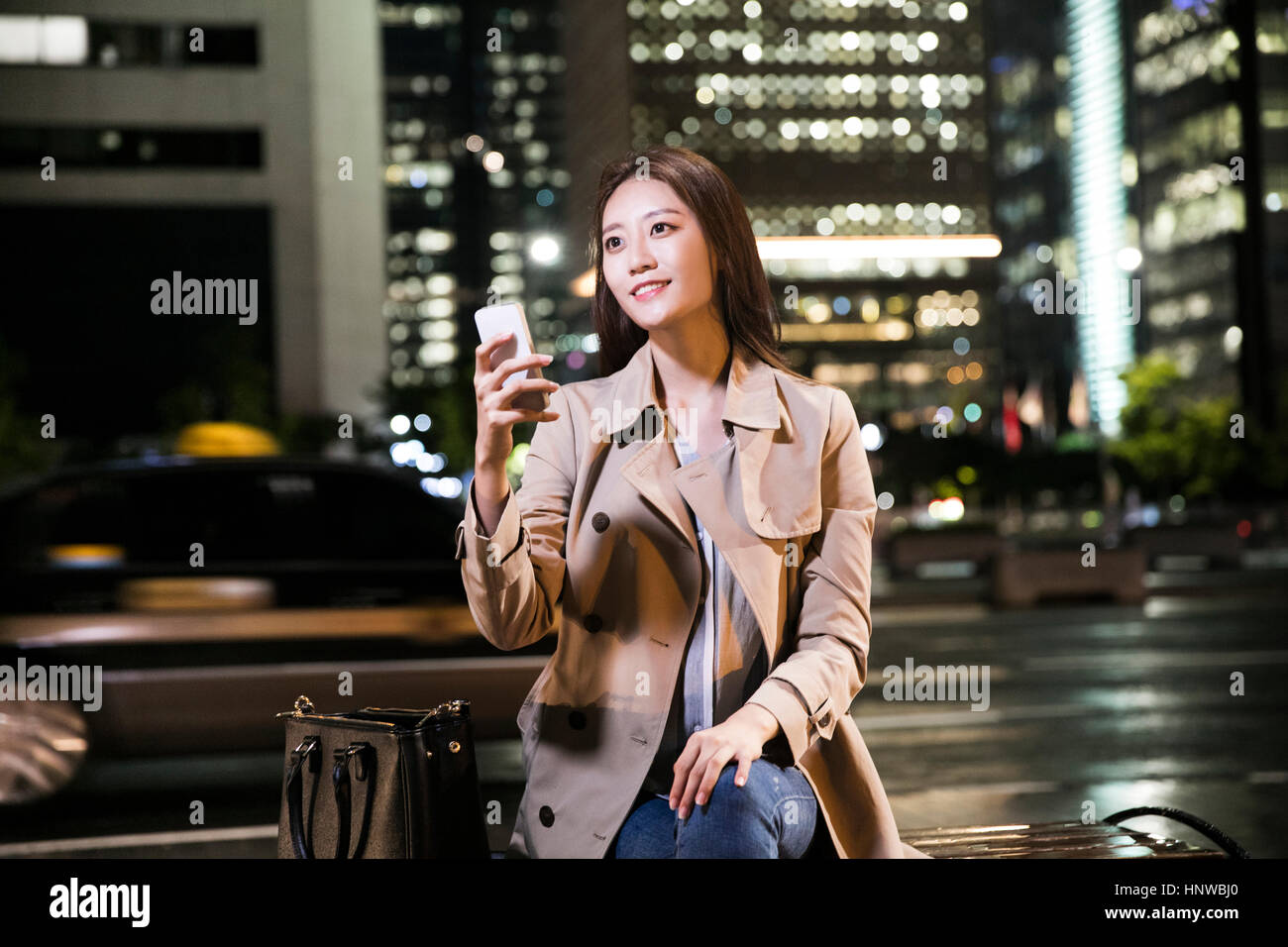 Young smiling woman at night Stock Photo - Alamy