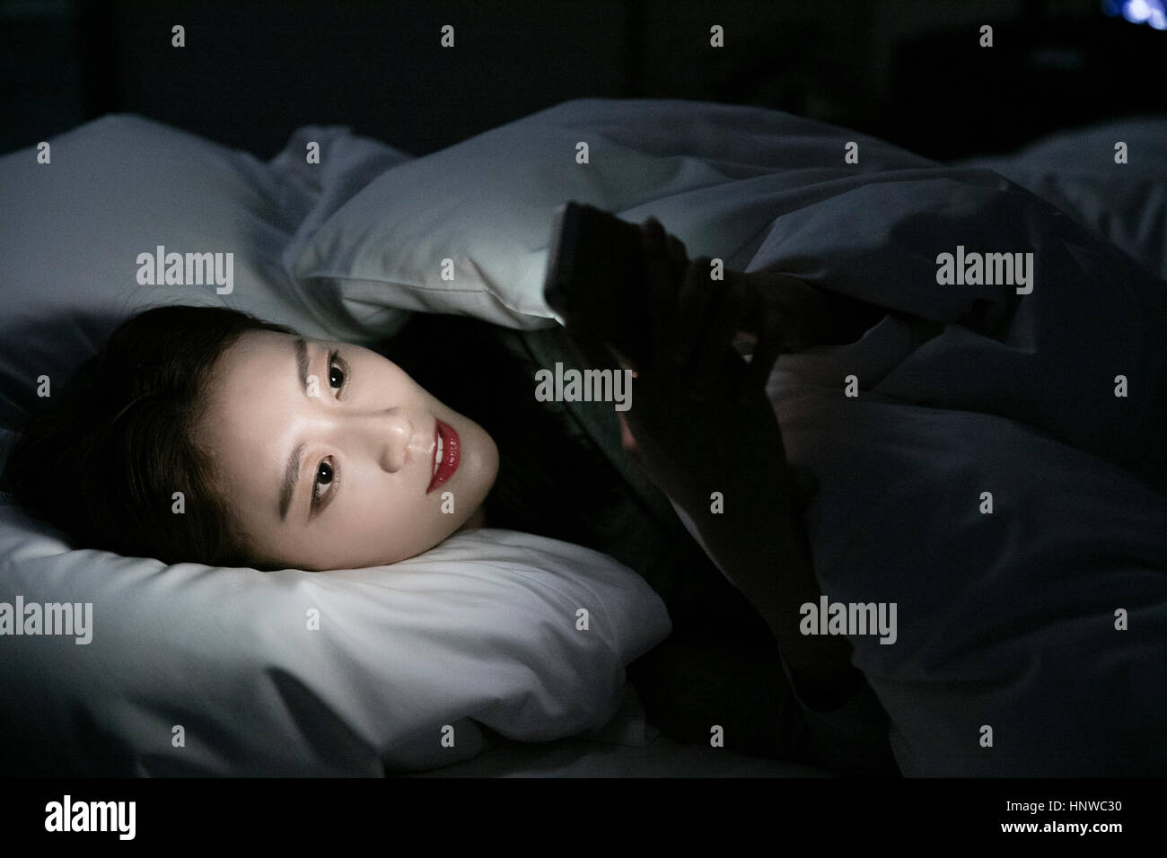 Asian female using smartphone night hi-res stock photography and images ...