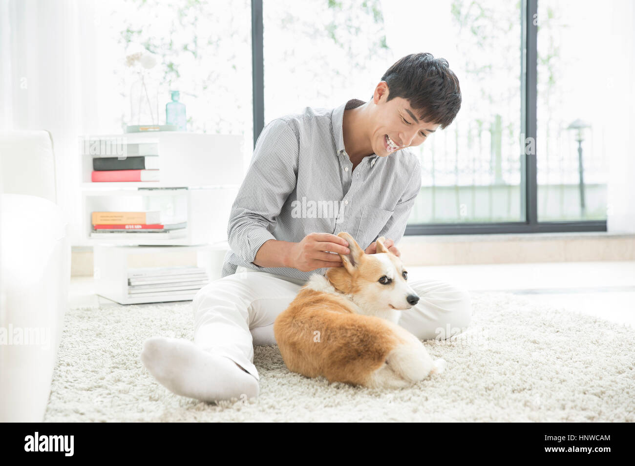 Smiling man with pet Stock Photo - Alamy
