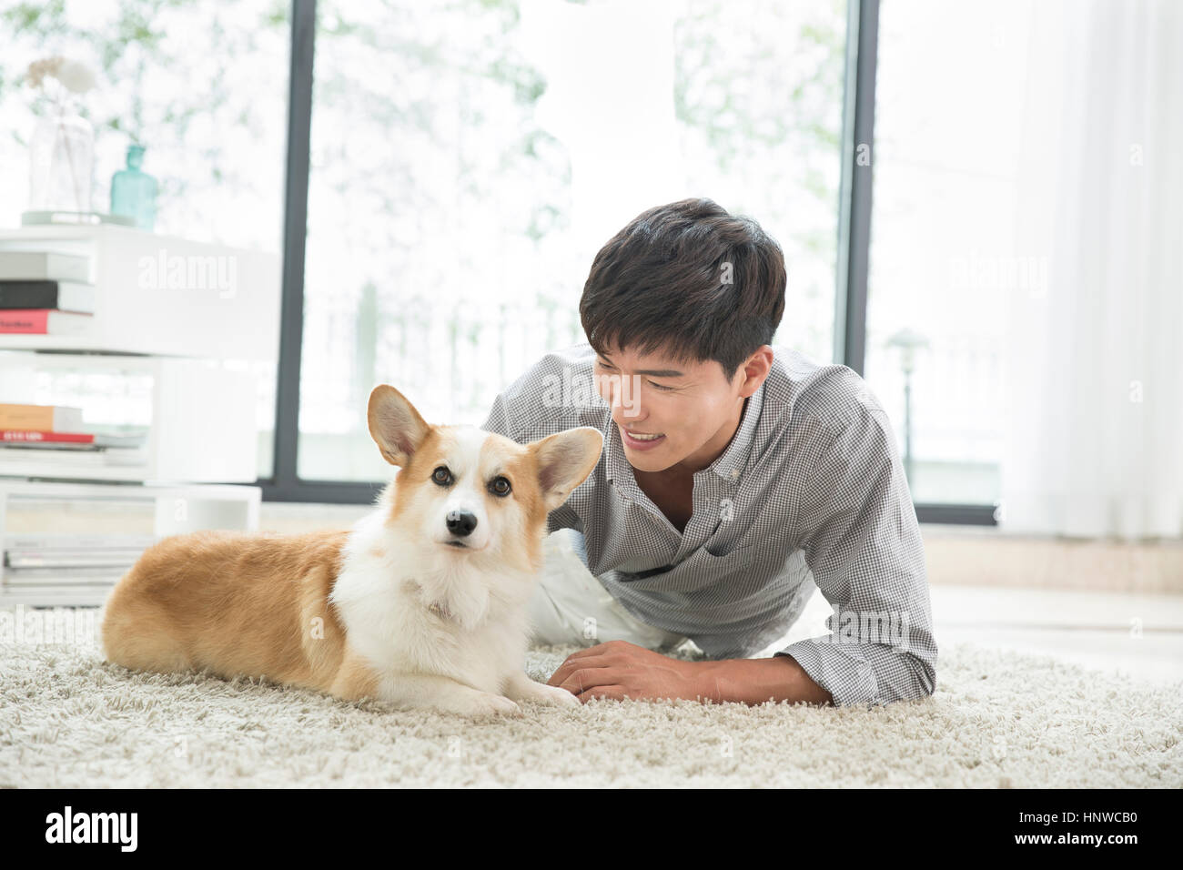 Smiling man with pet Stock Photo - Alamy