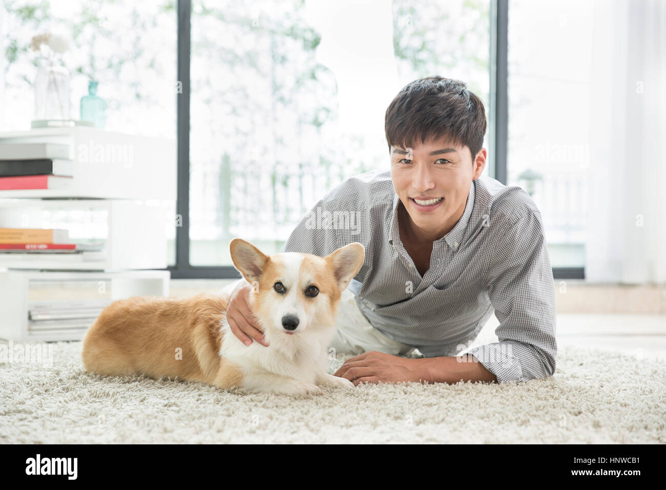 Smiling man with pet Stock Photo - Alamy