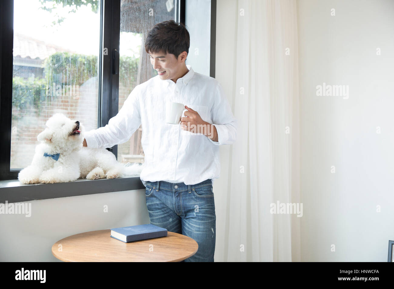 Smiling man with pet Stock Photo - Alamy