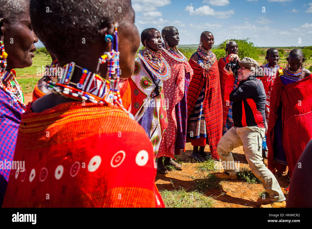 Tourist. Photographer taking pictures,A group of Masai women dancing a ...