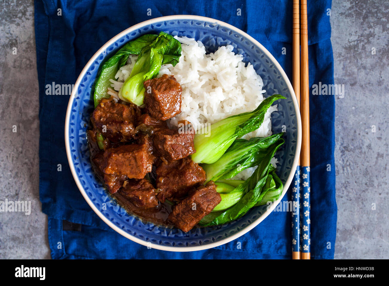 Spicy Chinese style braised beef with rice and pak choi Stock Photo - Alamy