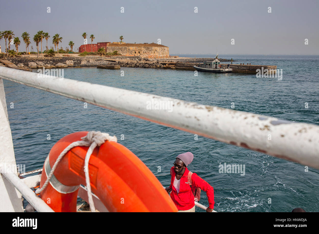 Ferry arriving at Goree Island, in background fort d´Estrees, near ...