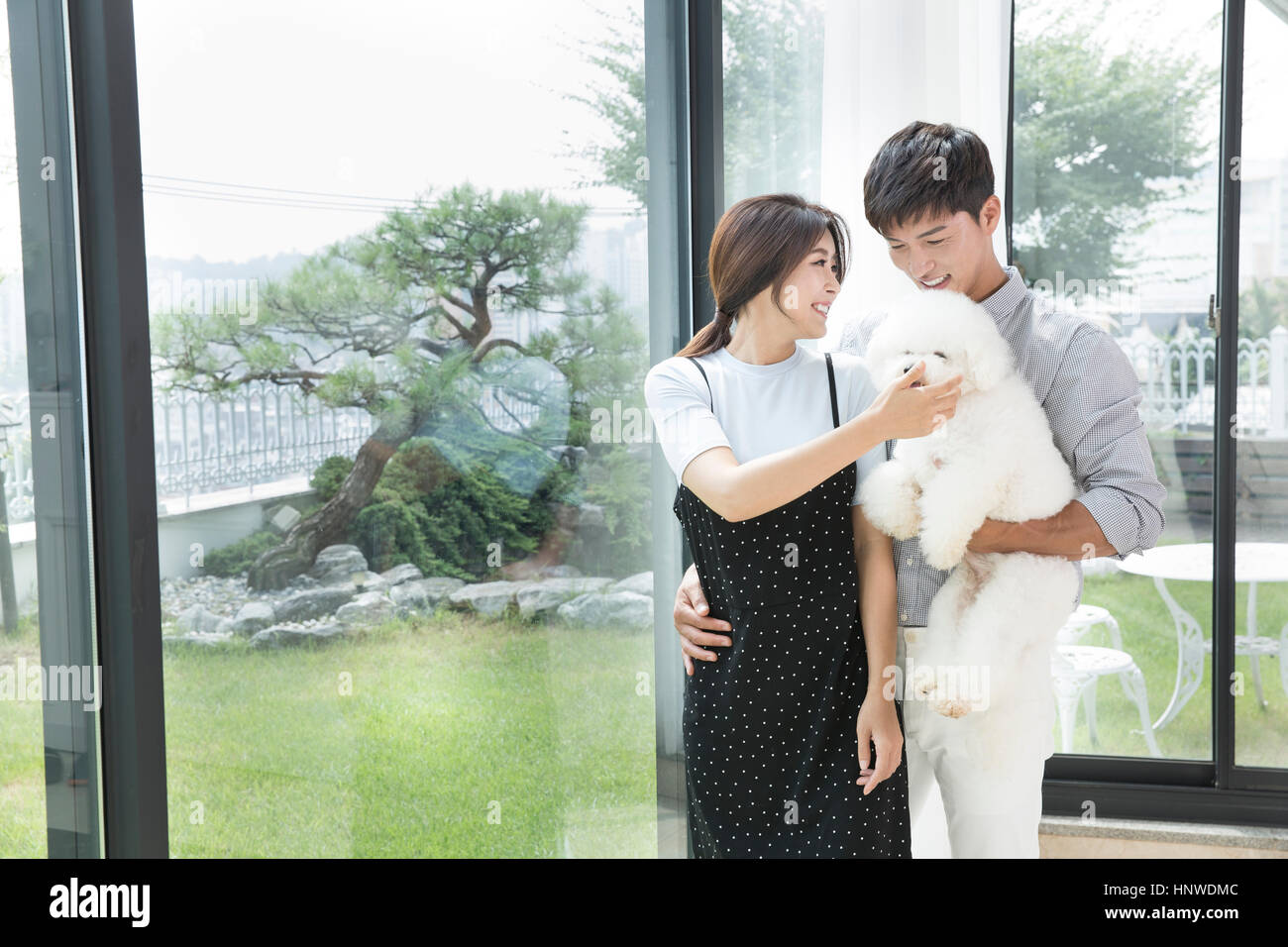 Loving couple with pet Stock Photo - Alamy