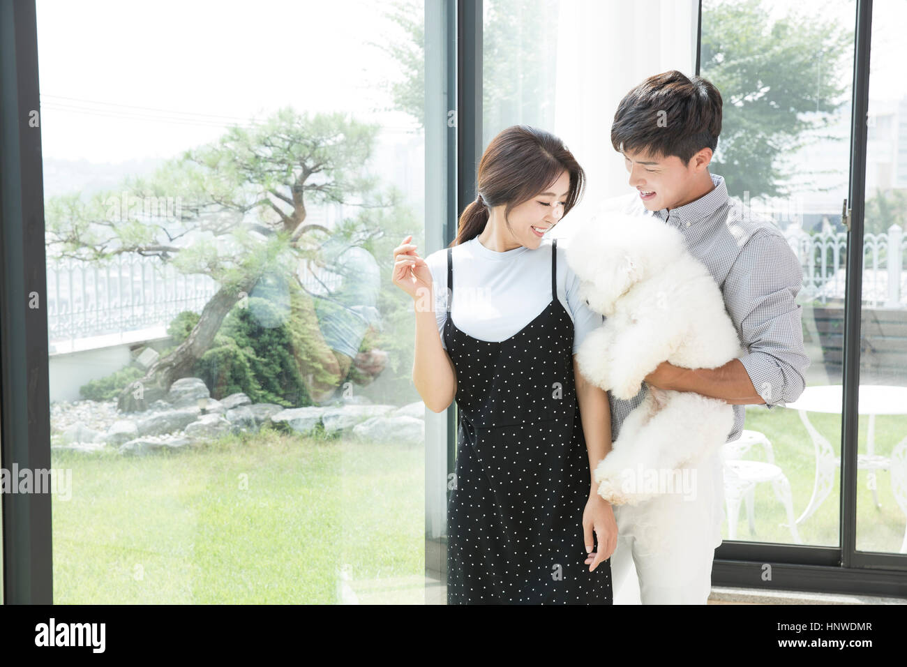 Loving couple with pet Stock Photo - Alamy