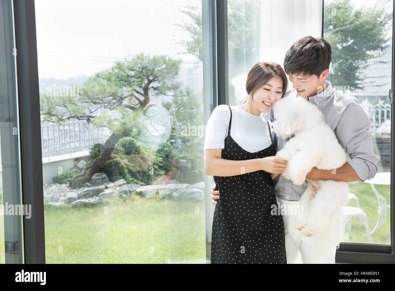 Loving couple with pet Stock Photo - Alamy