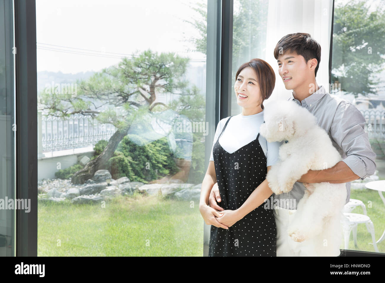 Loving couple with pet Stock Photo - Alamy