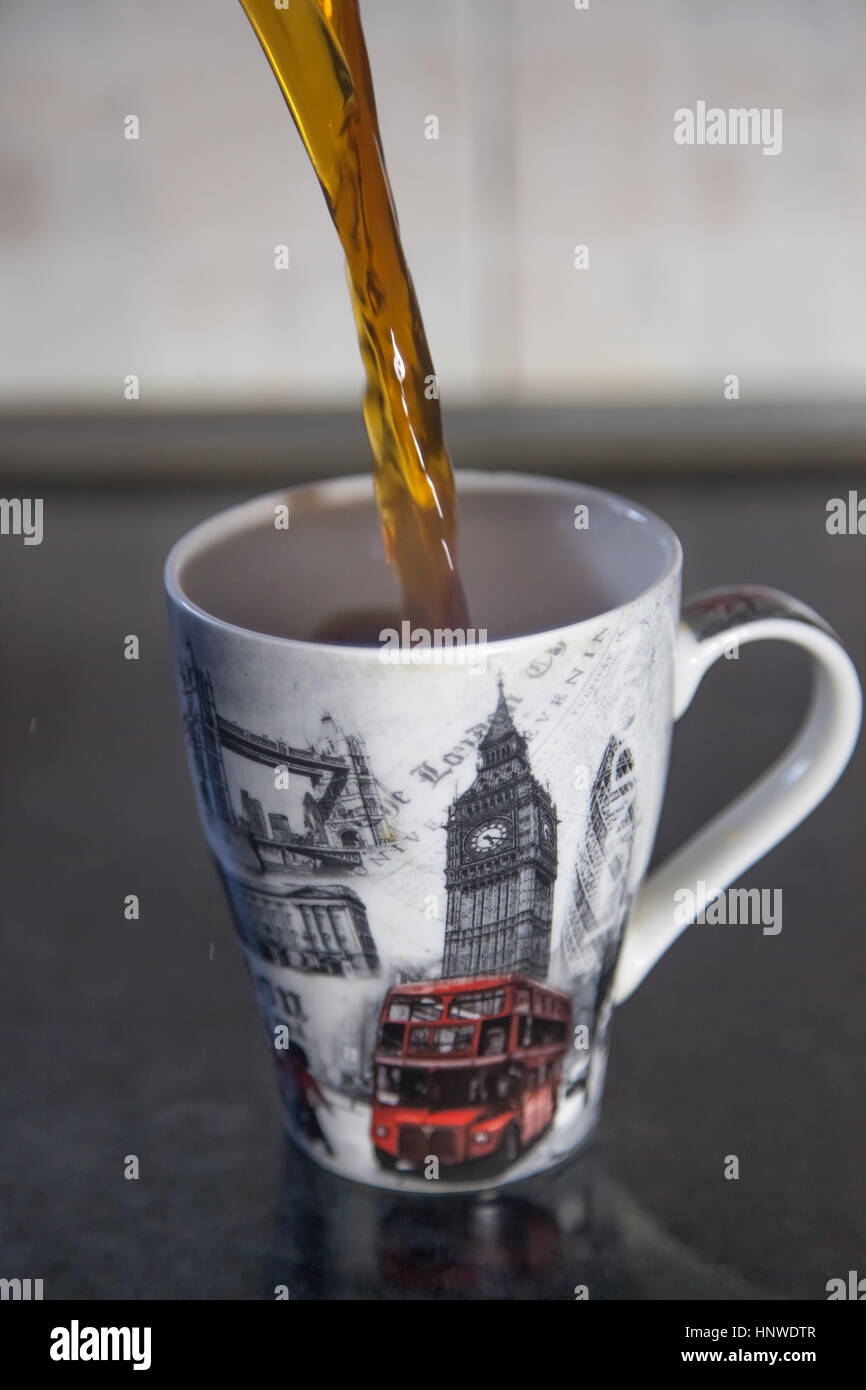 Pouring coffee in white mug Stock Photo - Alamy